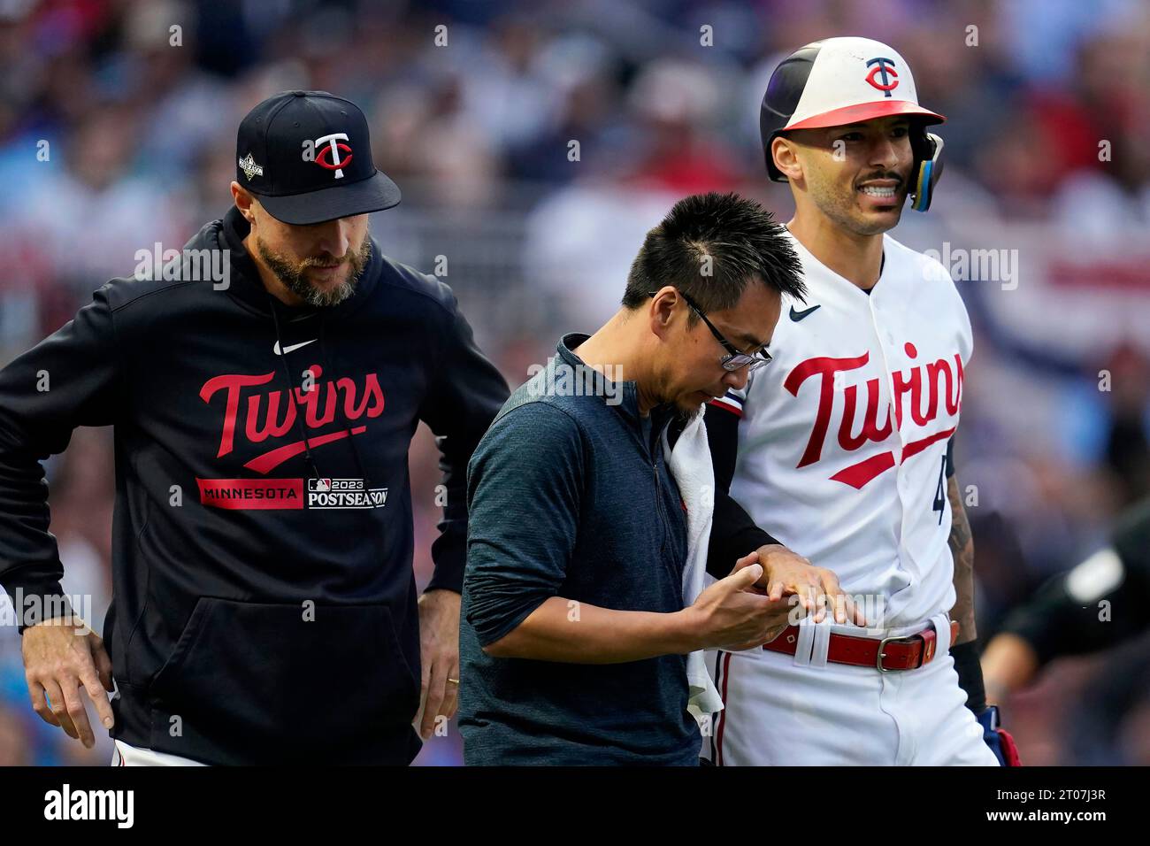 Minnesota Twins manager Rocco Baldelli, left, and a trainer check on ...