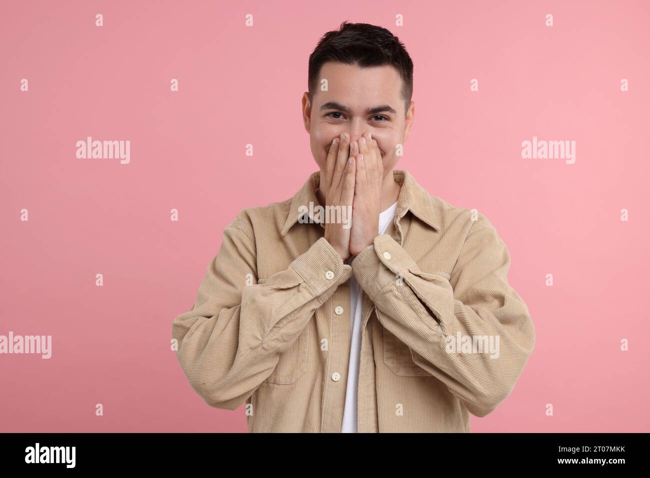 Embarrassed man covering face with hands on pink background Stock Photo ...