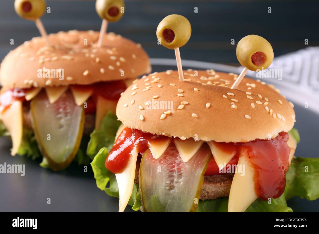 Cute monster burgers on plate, closeup. Halloween party food Stock ...