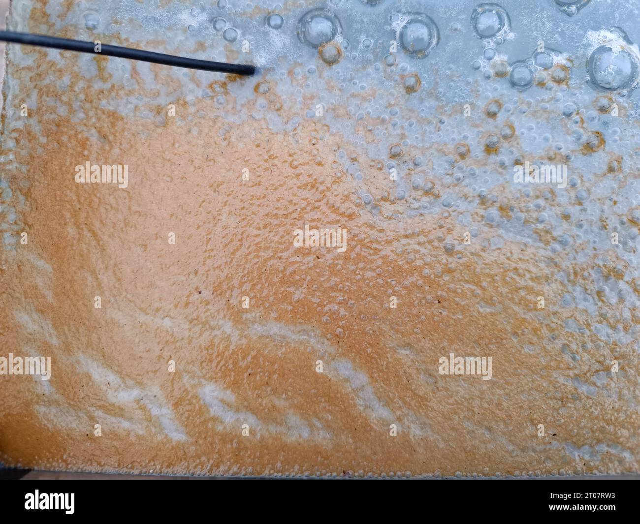 water surface in aquarium with bubbles and rust due to an experiment ...