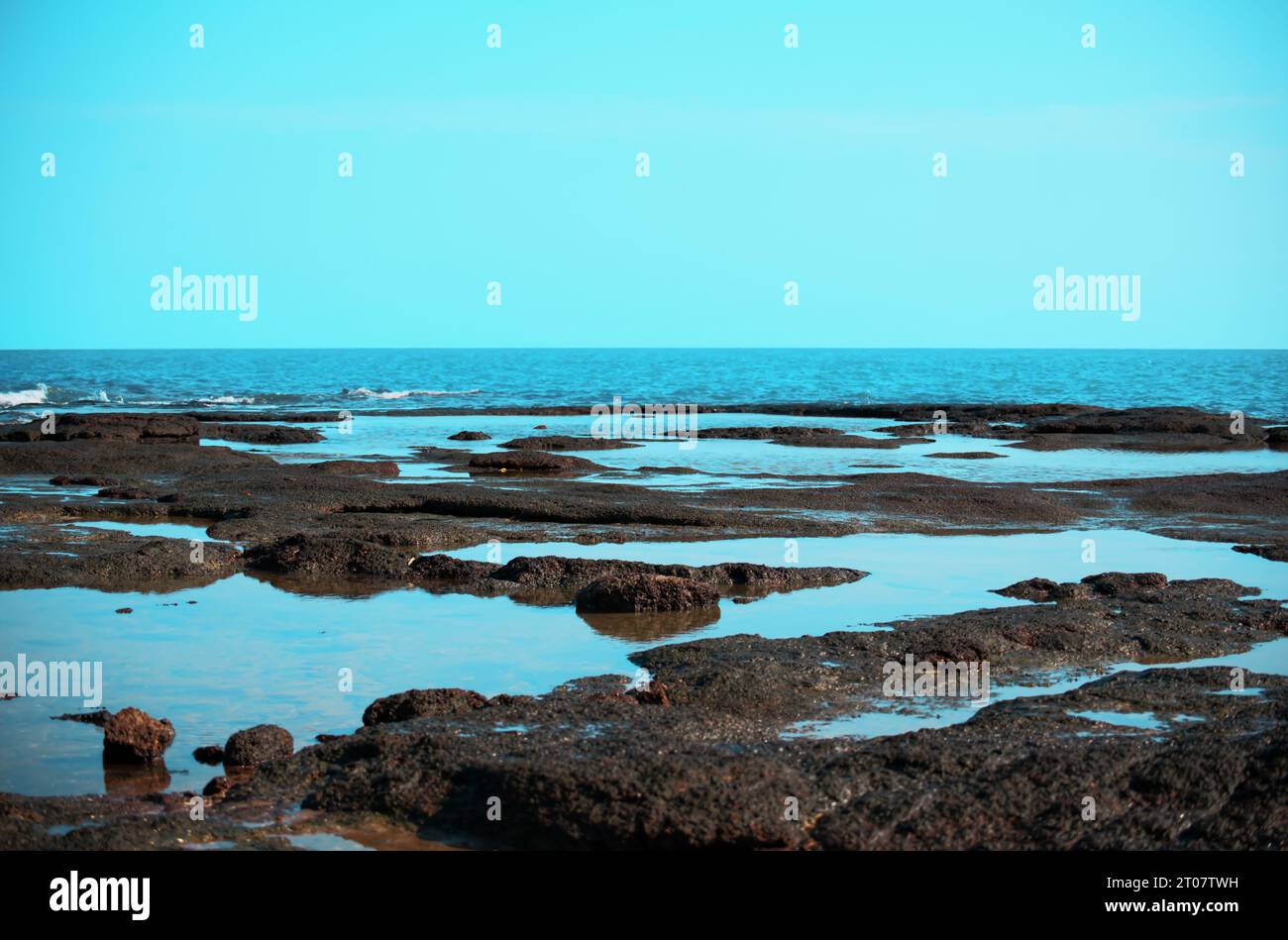 Tidal rock pools reflect the color of the sky and look like an infinity ...