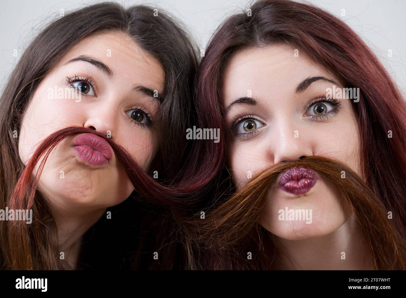 Carefree and radiant, two young women with impeccable makeup and hair ...