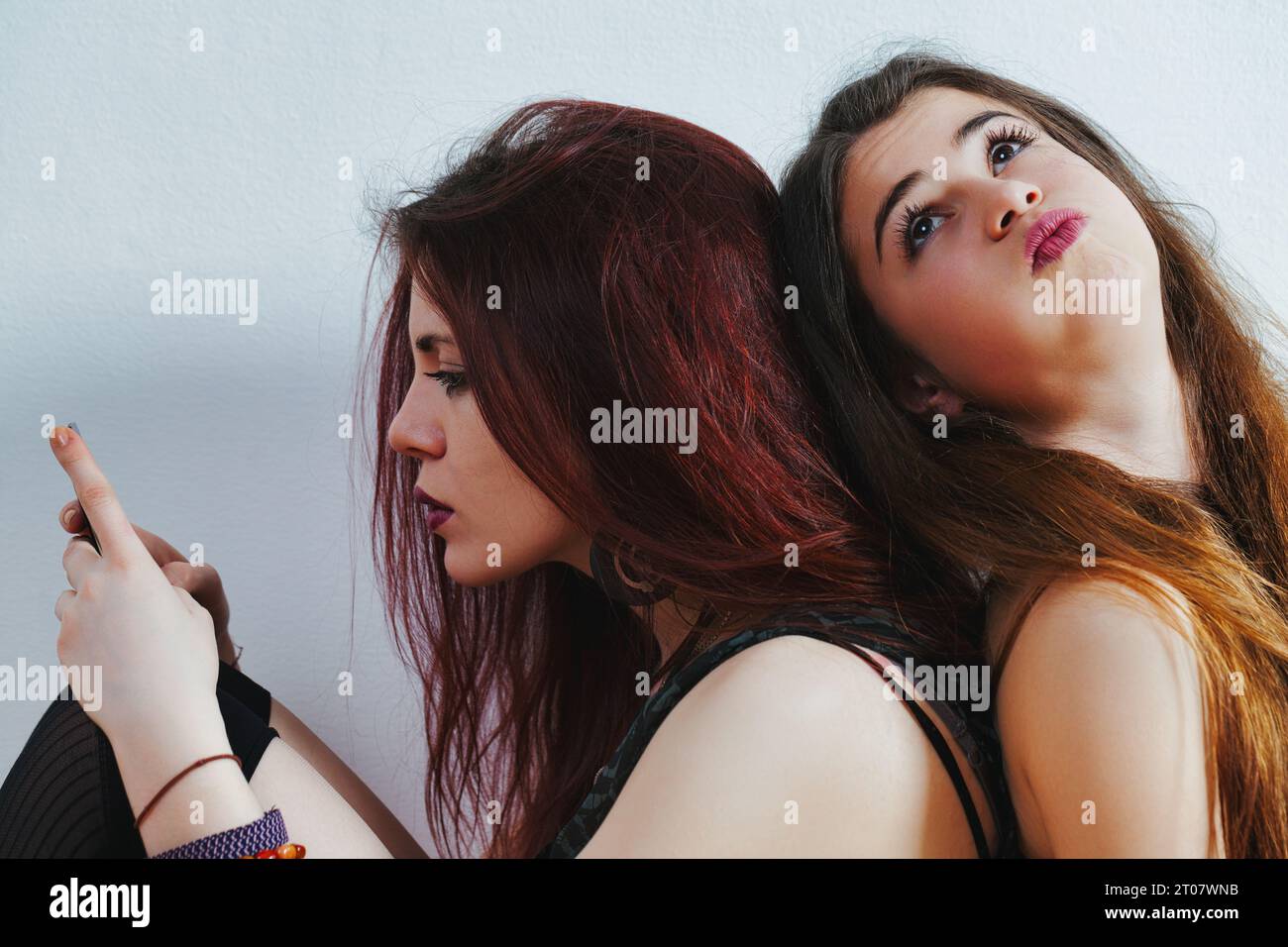 Two females navigate the paradox of being connected digitally but isolated physically. Their ...