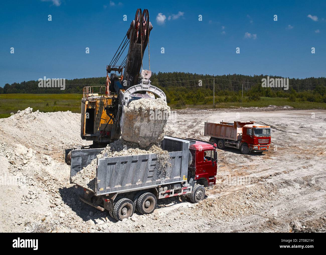 shovel mining excavator loads chalk into tipper truck in quarry Stock ...