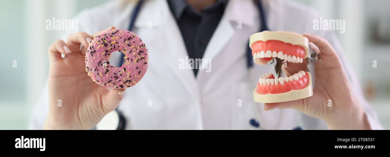 Dentist explains impact of sweets on teeth health in clinic Stock Photo ...