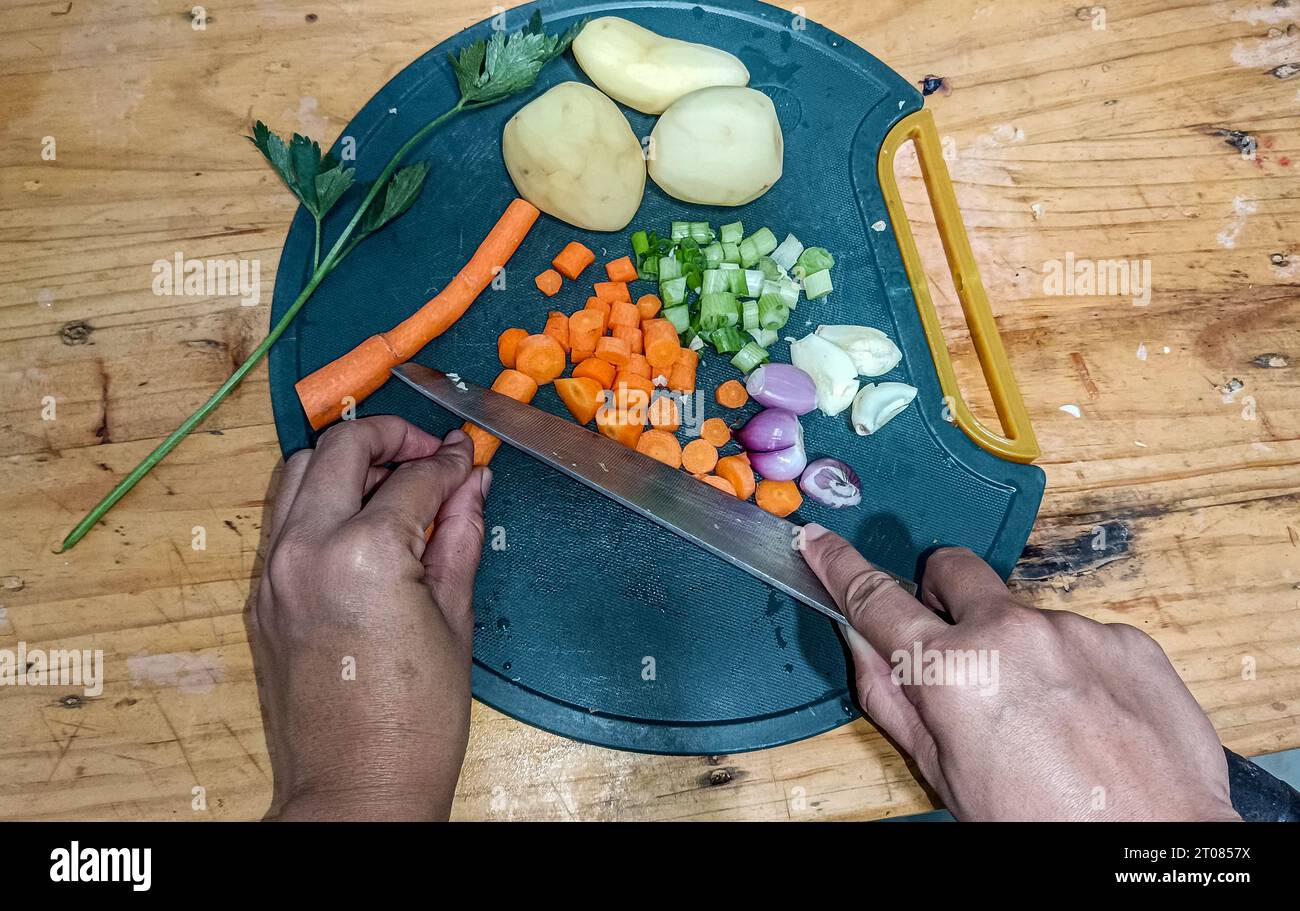 The activity of cutting vegetable ingredients using a knife and cutting ...