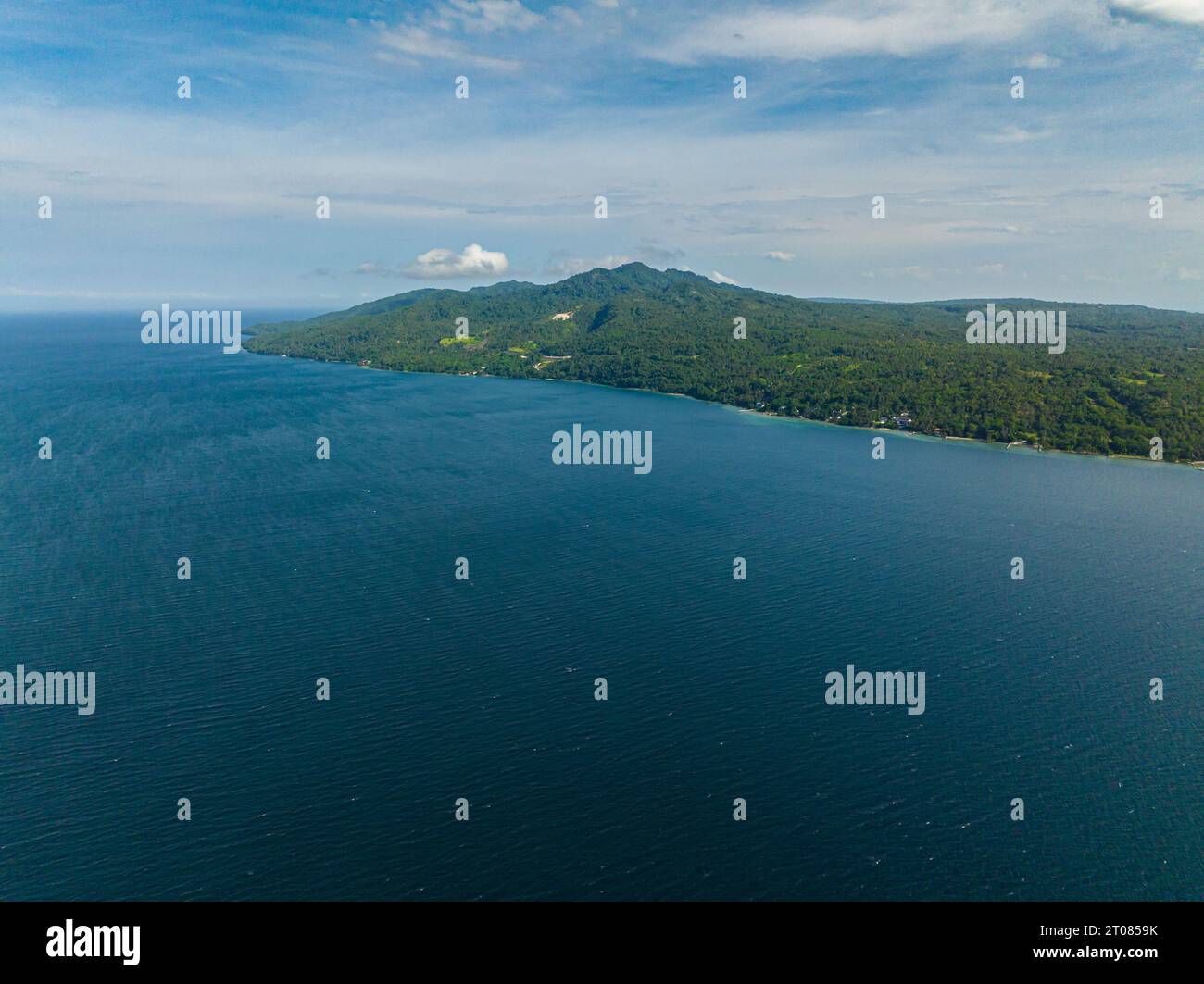 Aerial view of tropical island and blue sea. Blue sky and clouds. Samal ...