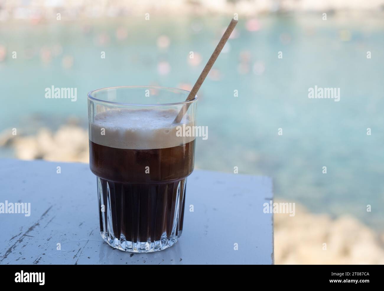 Fredo espresso iced coffee on the beach. Refreshment outdoor. Black ...