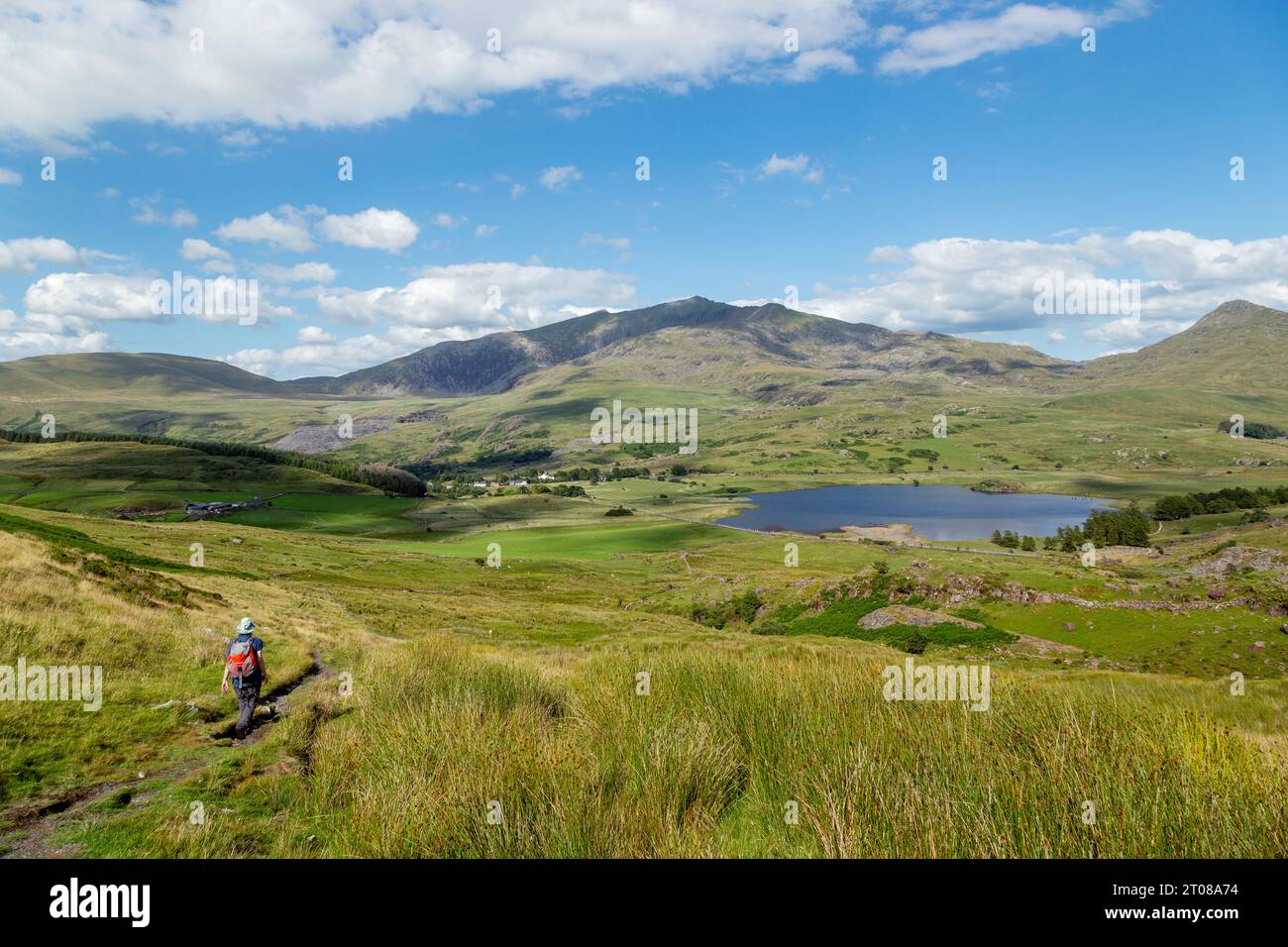 A walker in the Snowdonia national park walking towards Llyn y Gader ...