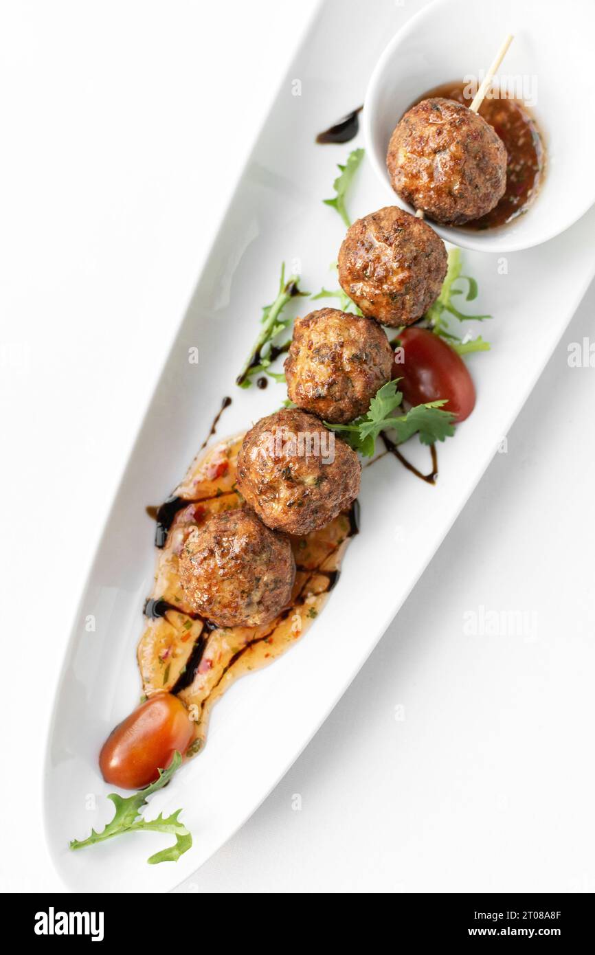 thai fish cake balls in gourmet contemporary restaurant on white plate ...