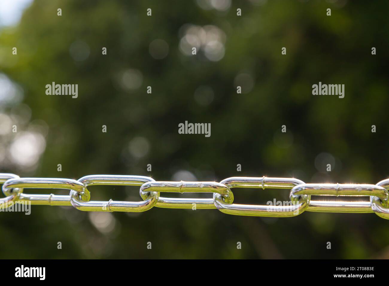 steel non-rusty chain on grass background, frame Stock Photo - Alamy