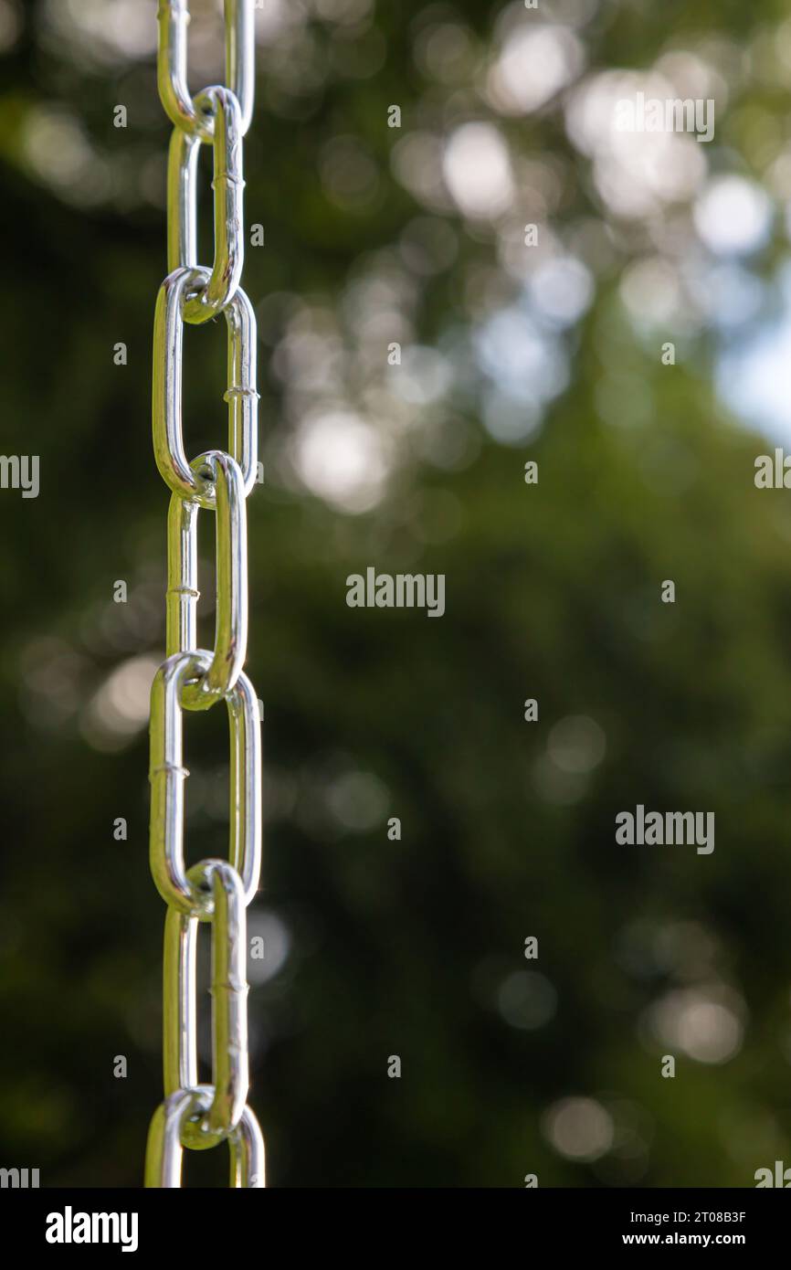 steel non-rusty chain on grass background, frame Stock Photo - Alamy