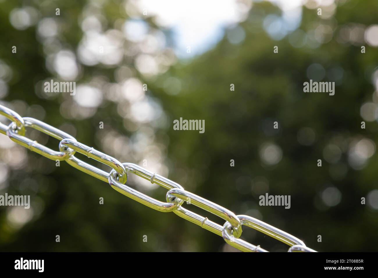 steel non-rusty chain on grass background, frame Stock Photo - Alamy