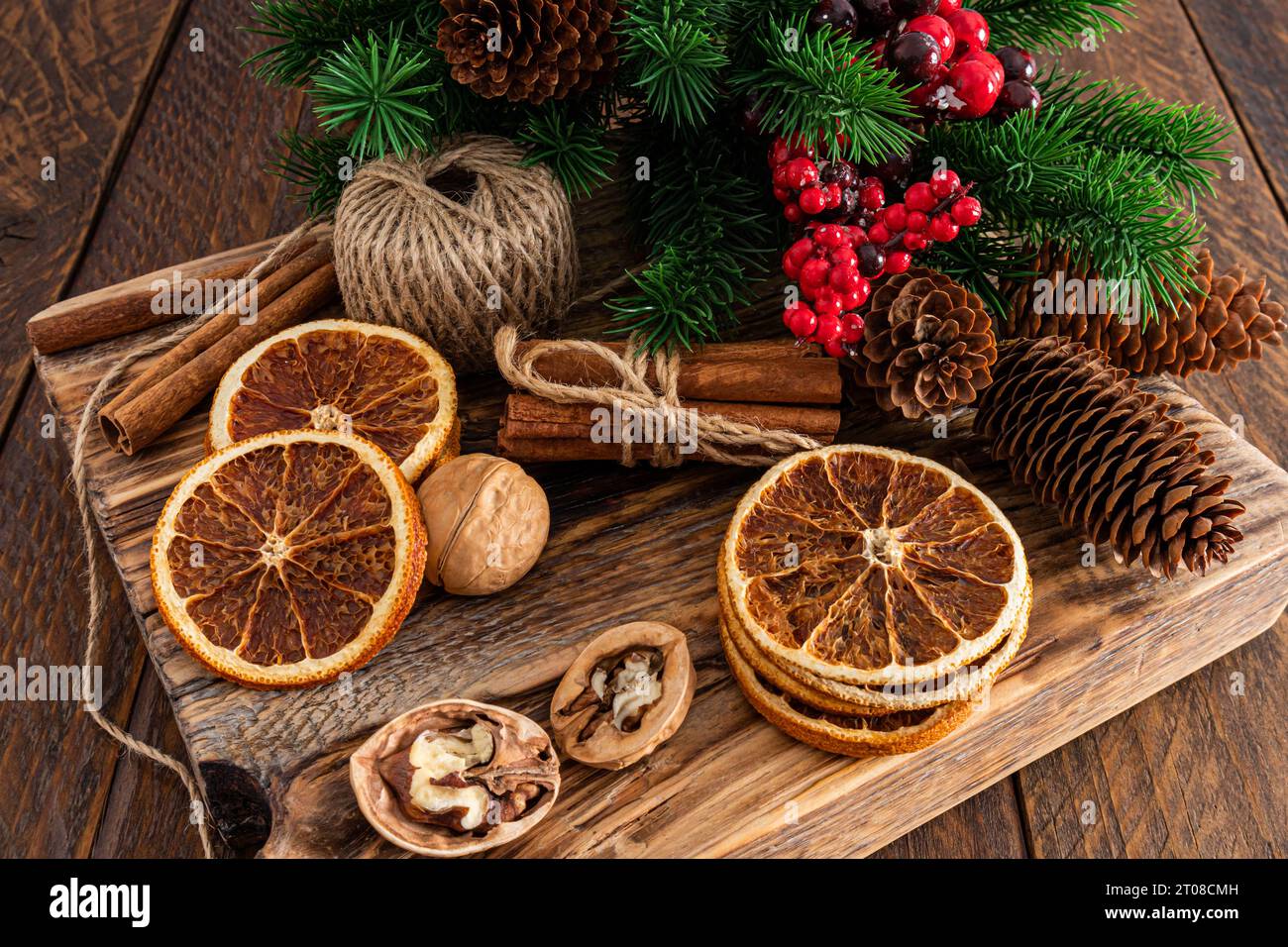 Dried orange slices, walnuts, cinnamon sticks, green spruce branches on ...