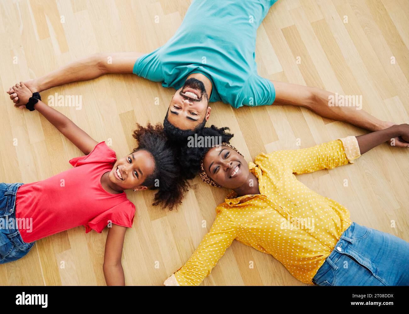 child daughter family happy mother father floor lying down fun together ...
