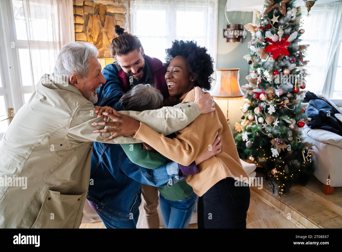 Happy multiethnic multi-generational family enjoying Christmas time ...