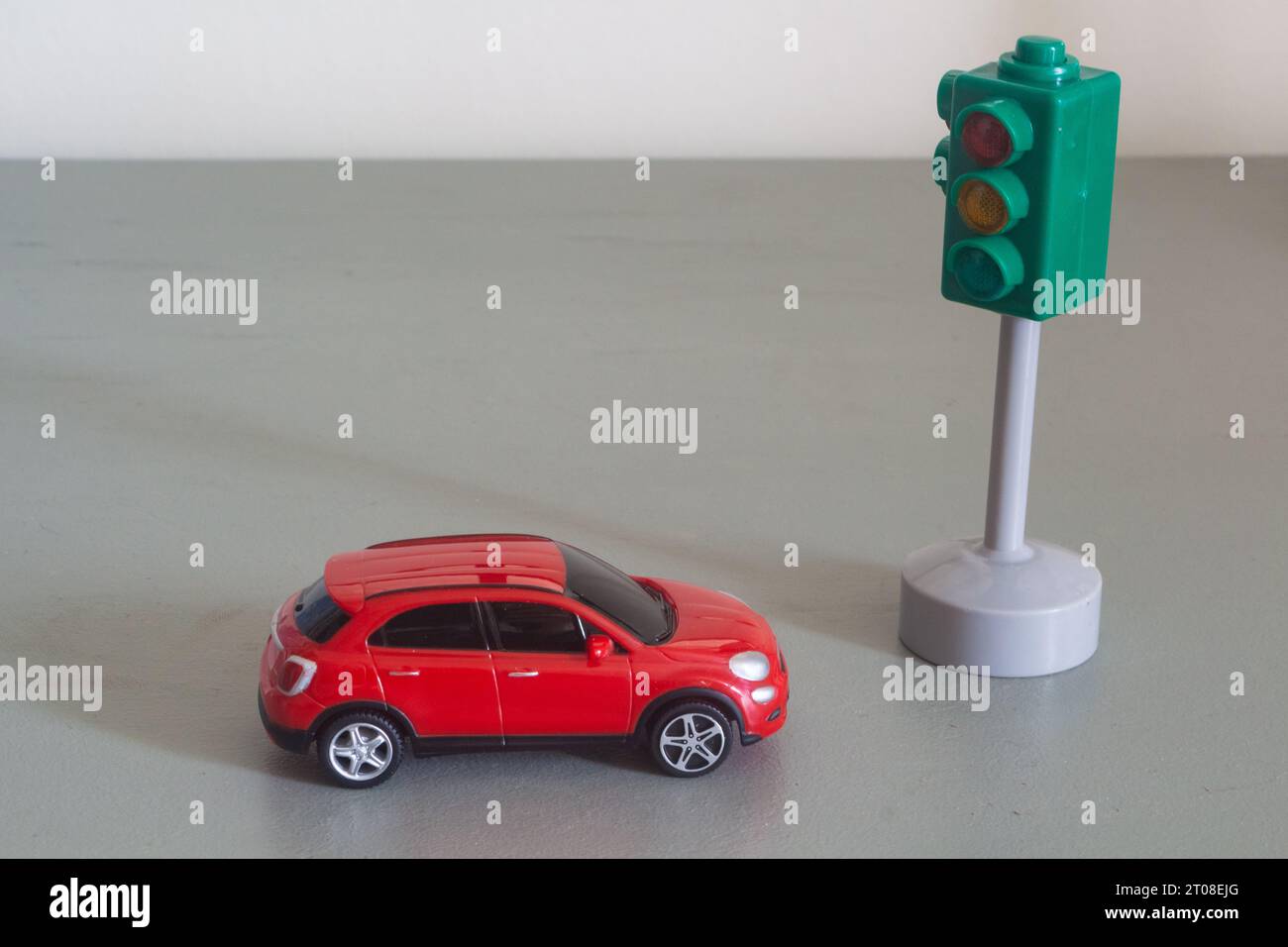 Red toy car and green traffic light Stock Photo - Alamy