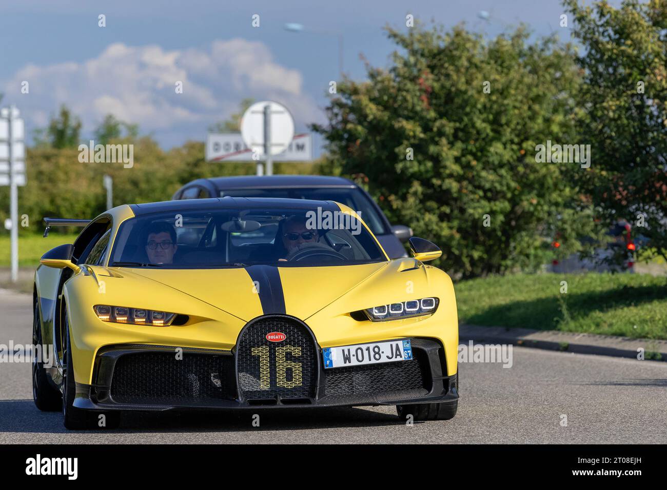 Yellow Bugatti Chiron Pur Sport driving on the road Stock Photo - Alamy