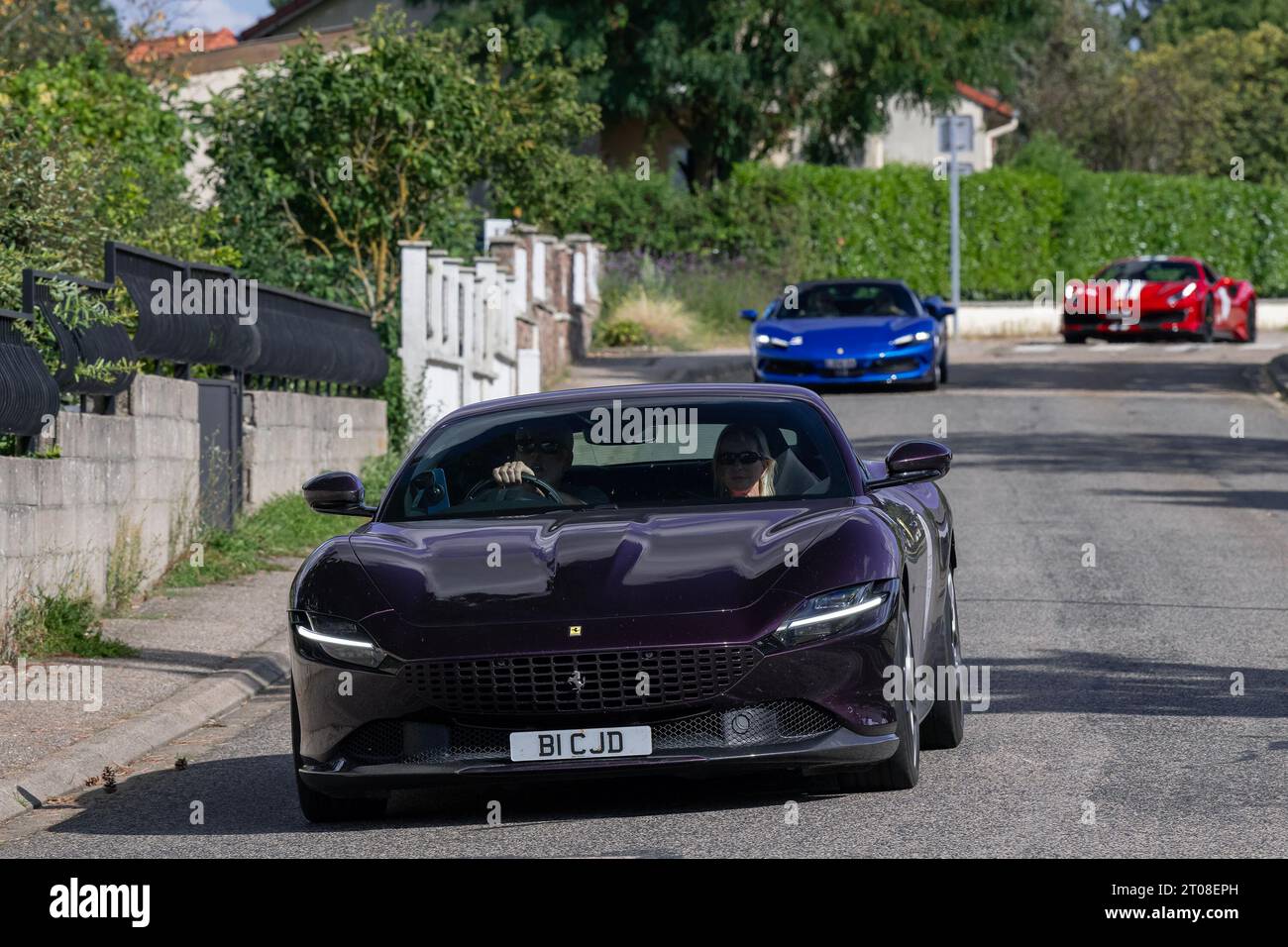Purple Ferrari Roma driving on the road Stock Photo - Alamy