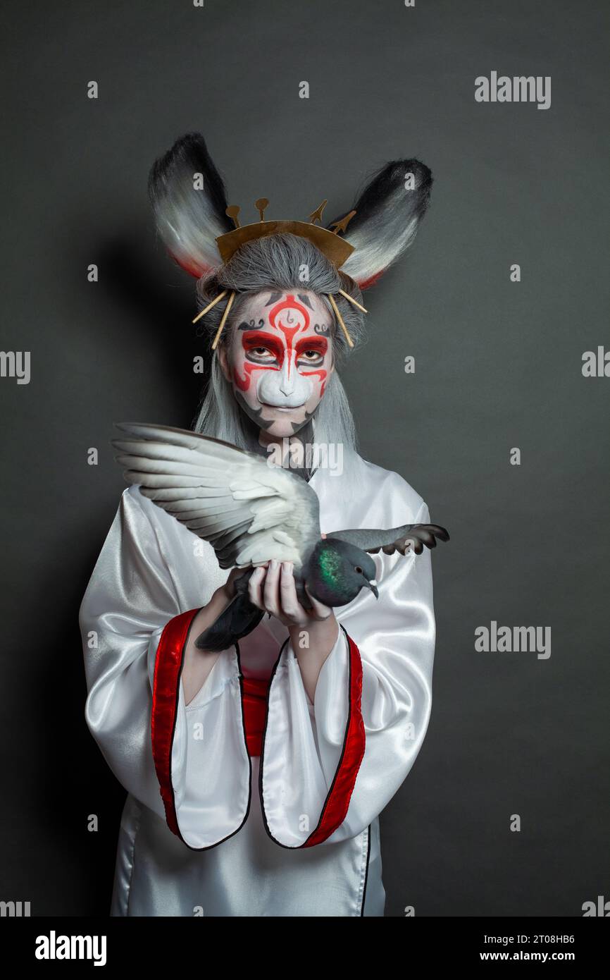 Fashion beauty portrait of perfect young woman rabbit with pigeon bird ...