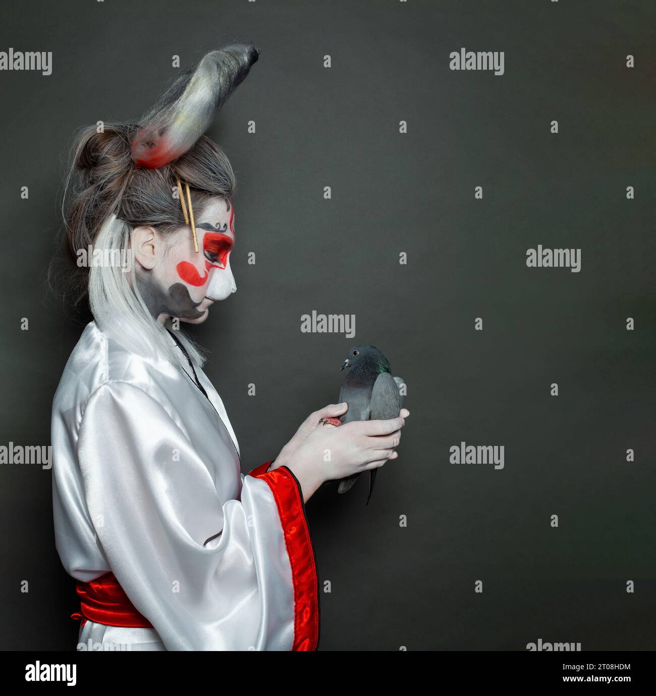 Fairy tale character. Woman hare holding pigeon bird on black ...