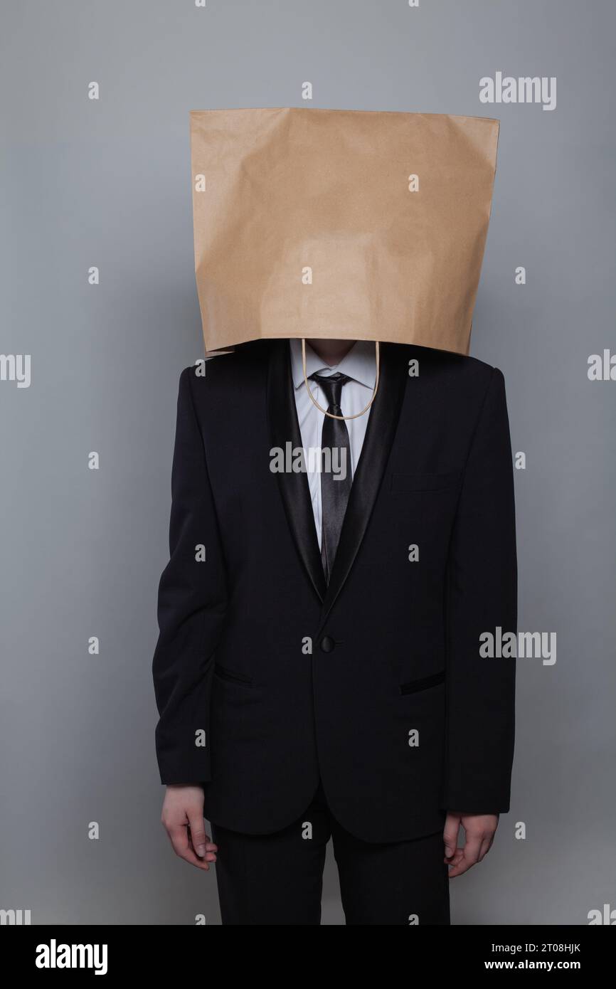 Portrait of anonymous businessman wearing blank empty paper bag on head ...