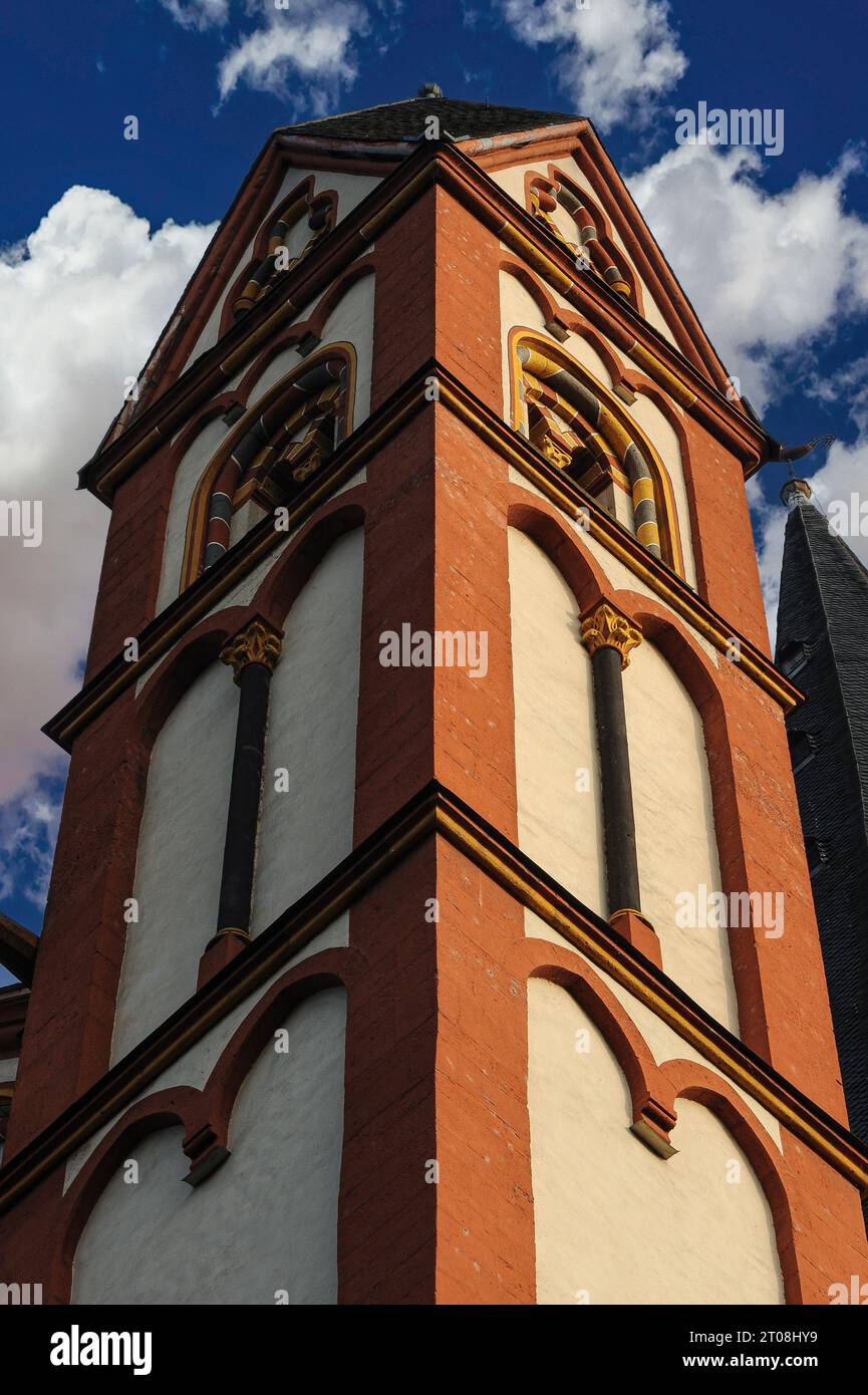 Brightly coloured square tower and slightly curving spire of Late ...