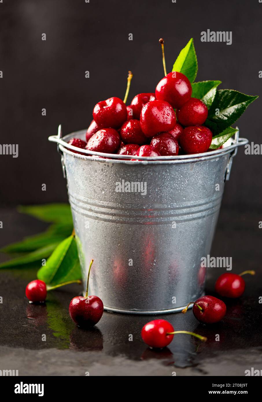 Cherry summer background. A large number of cherries with leaves on the ...