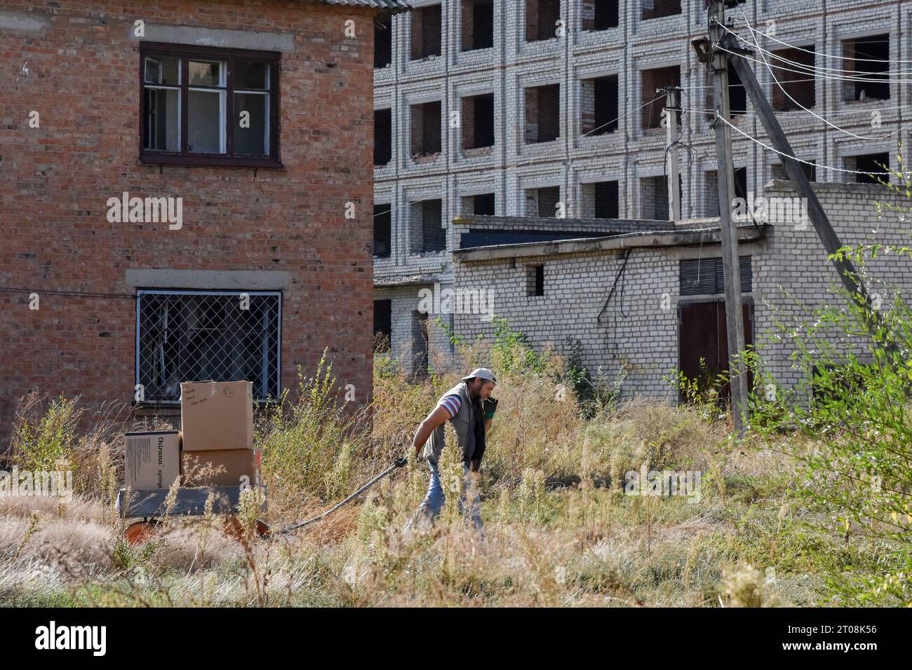 Orikhiv, Ukraine. 03rd Oct, 2023. A man is walking by the damaged city ...