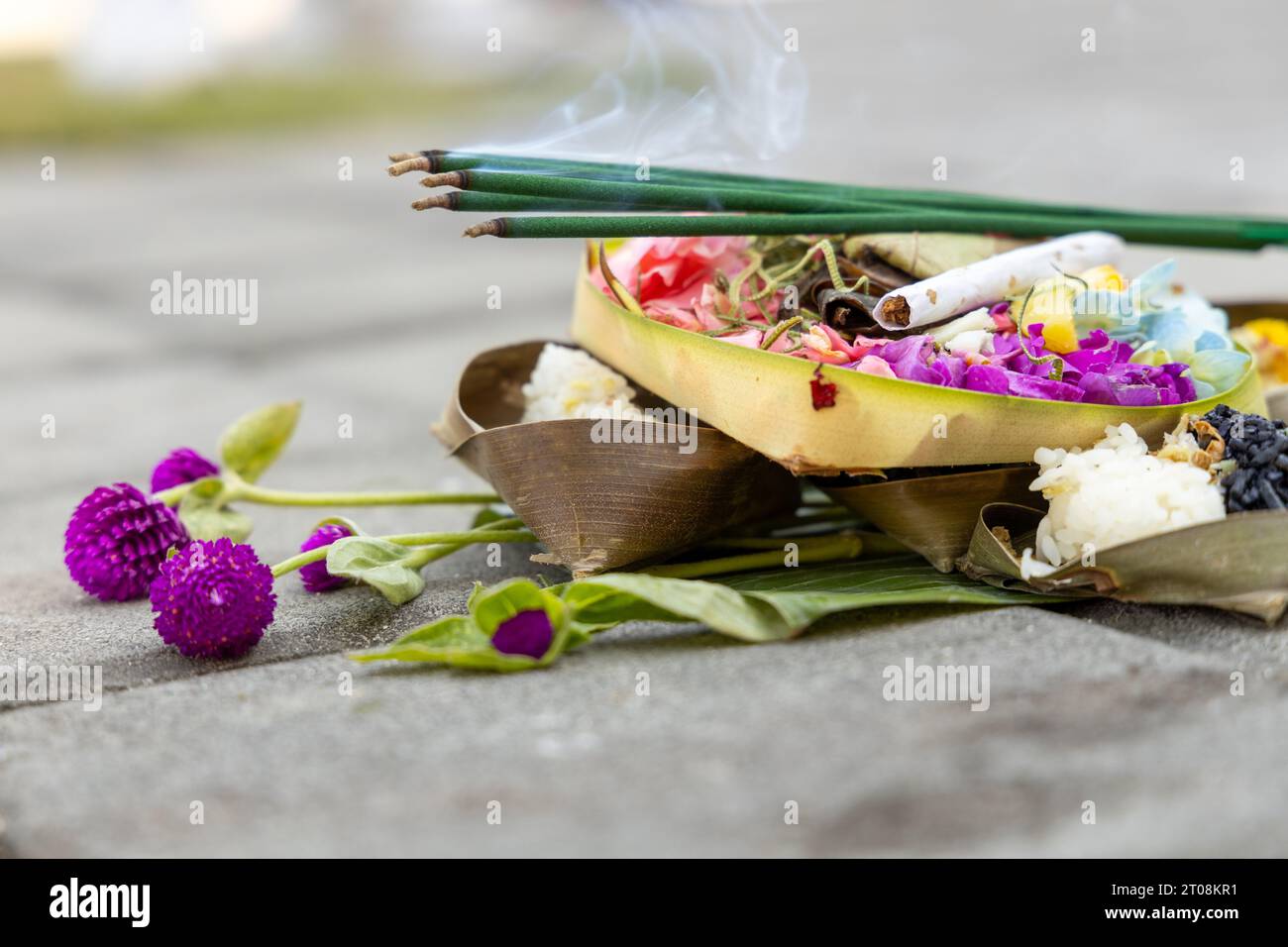 A balinese offering or Banten with burning incense visible Stock Photo ...
