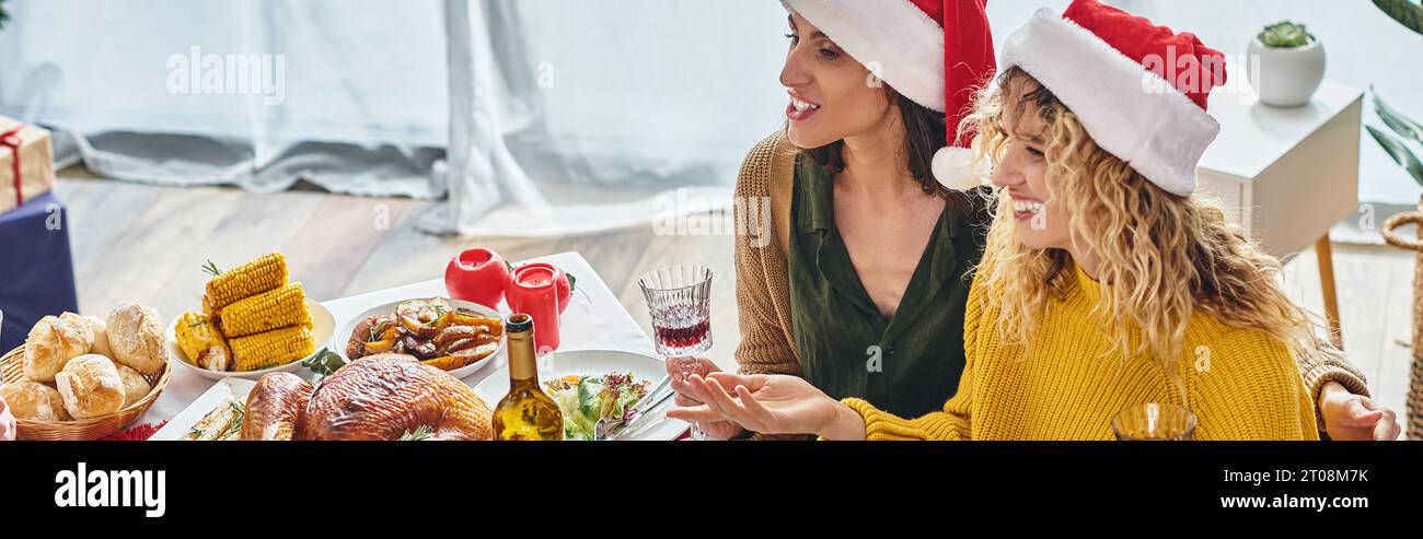 cheerful lgbt couple smiling and talking to other family members ...