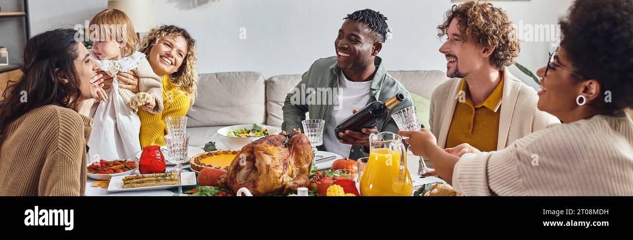 banner, african american man pouring wine into glass, multiracial ...