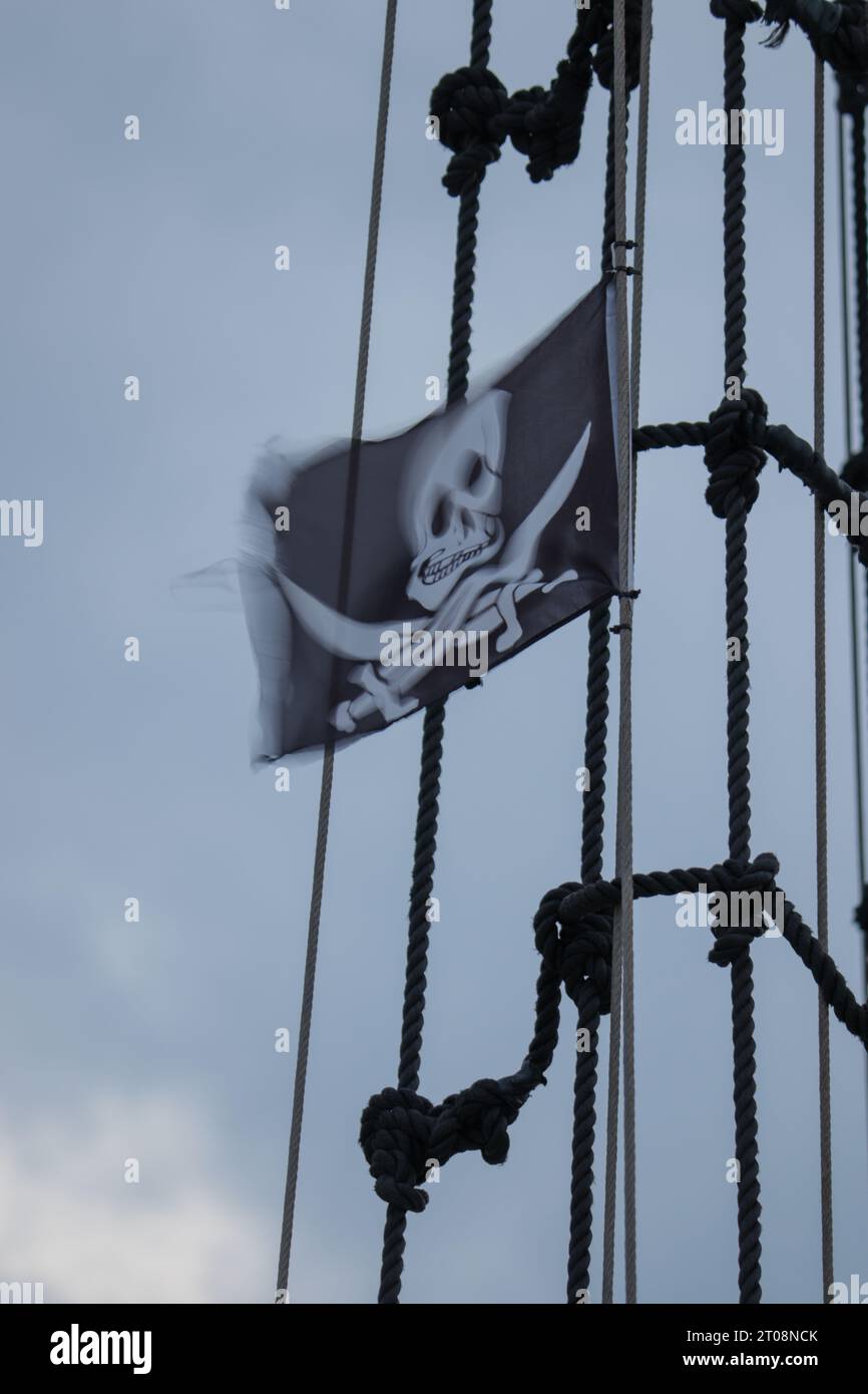 a pirate flag flying in the wind Stock Photo - Alamy