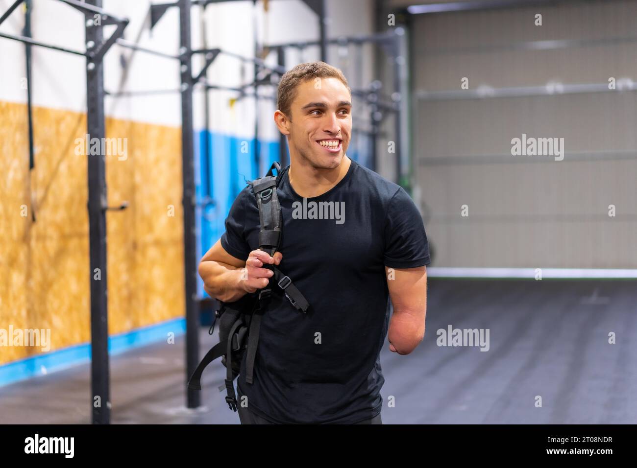 Happy man with one arm amputated on his way to the gym Stock Photo - Alamy