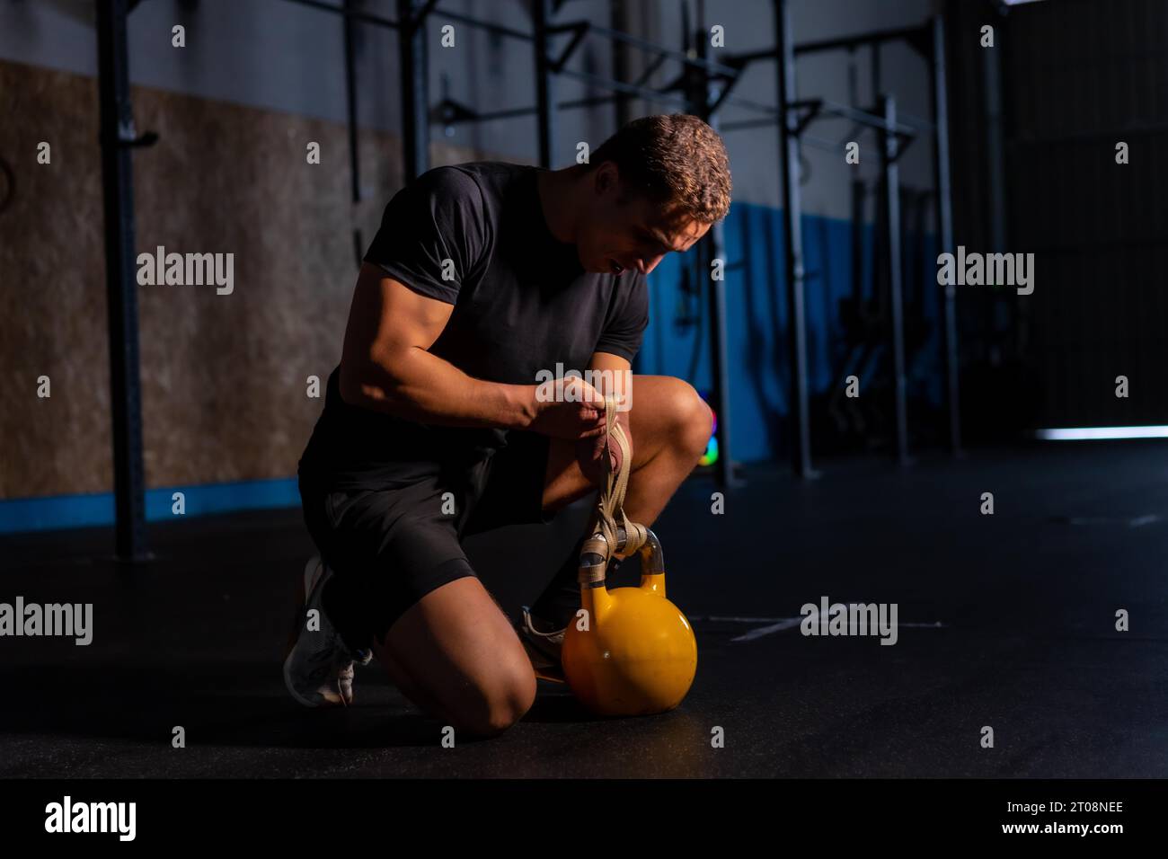 Dark artistic portrait of a handicapped man in a gym ready to exercise ...