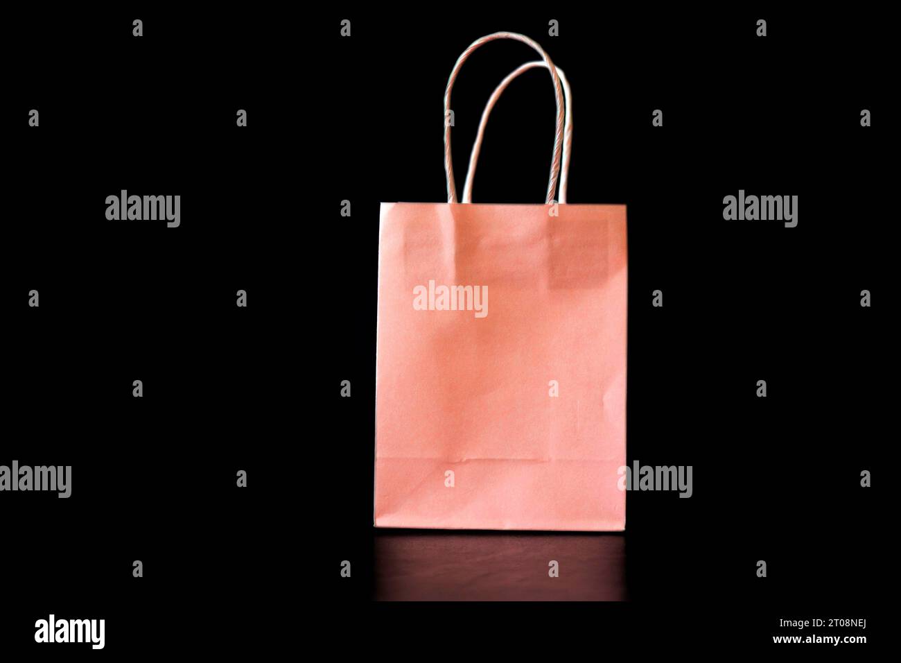 Small pink paper bag, studio photography with black background Stock ...