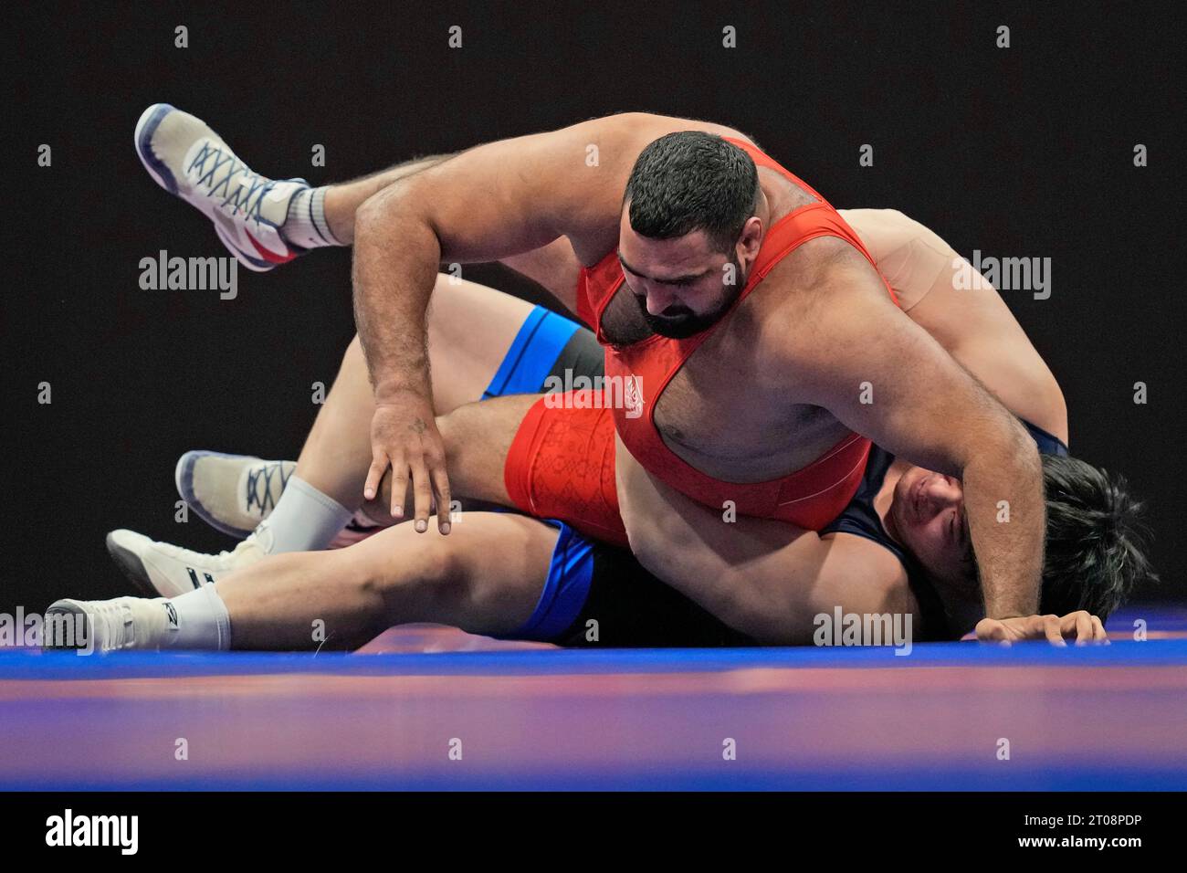 India's Naveen, red, and South Korea's Kim Minseok compete during their ...