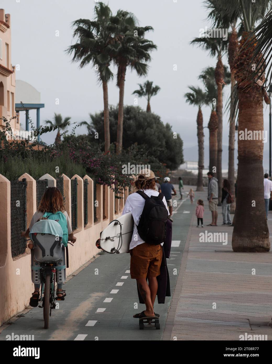 People moving to the beach with a bike and a skateboard Stock Photo - Alamy