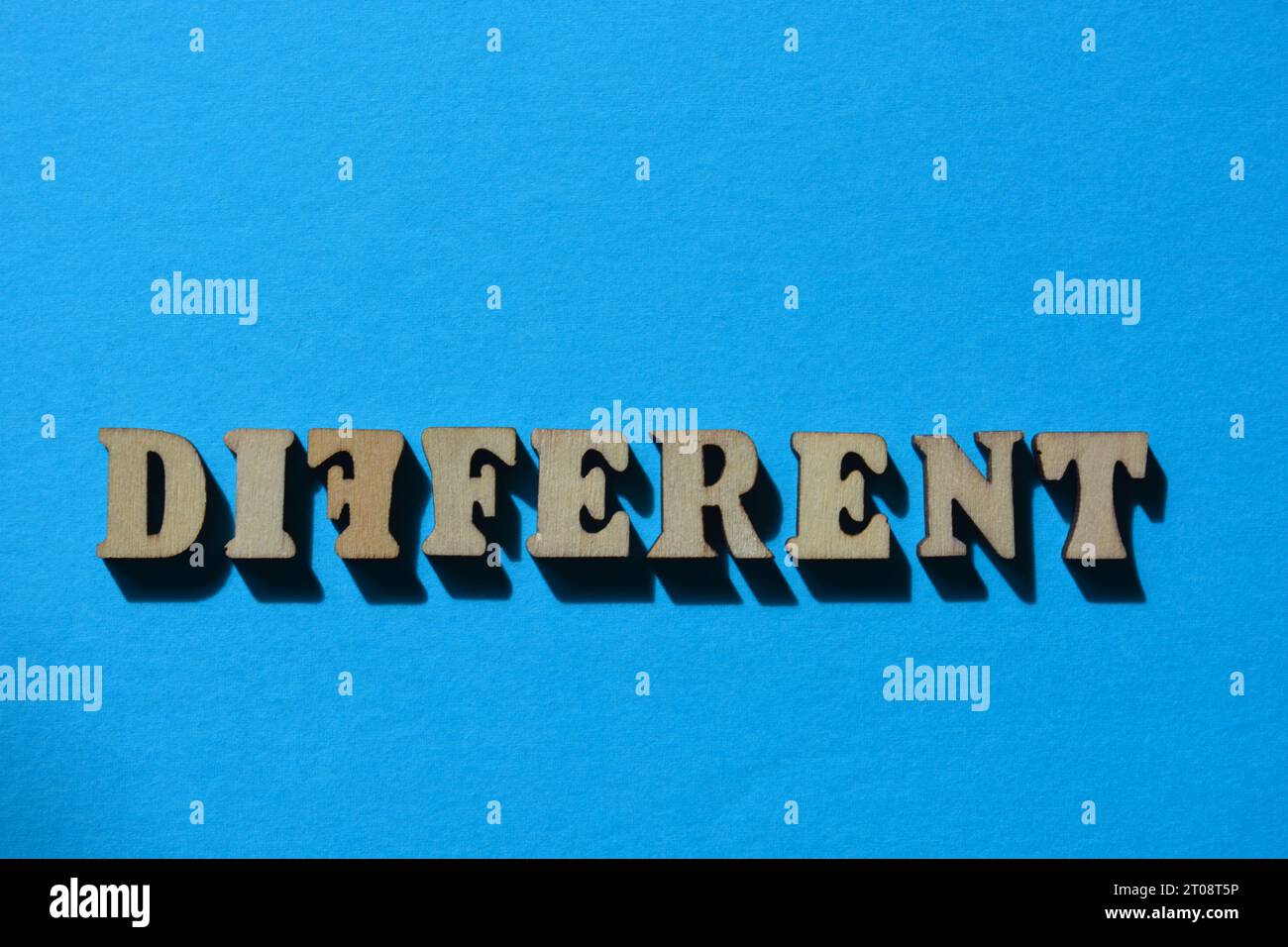 Different, with a backward F, word in wooden alphabet letters isolated ...
