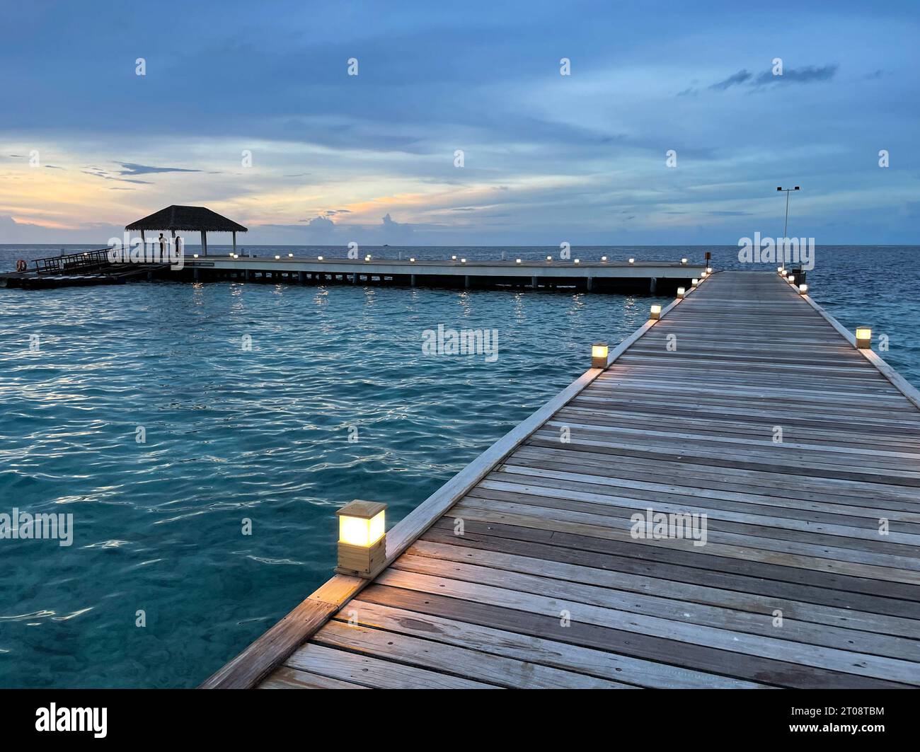 A beautiful view of the entrance of a resort in middle of the ocean ...