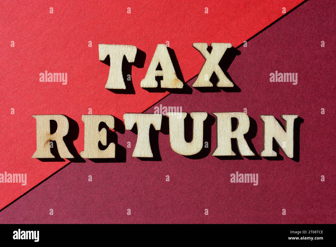 Tax Return, words in wooden alphabet letters isolated on red background ...