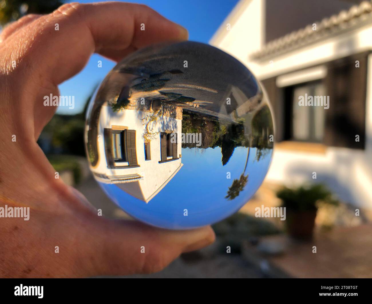 Crystal ball in hand, refraction photography, Looking through lens to a ...