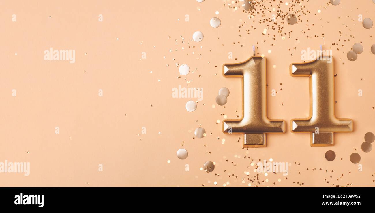 Gold candles in the form of number eleven Stock Photo - Alamy