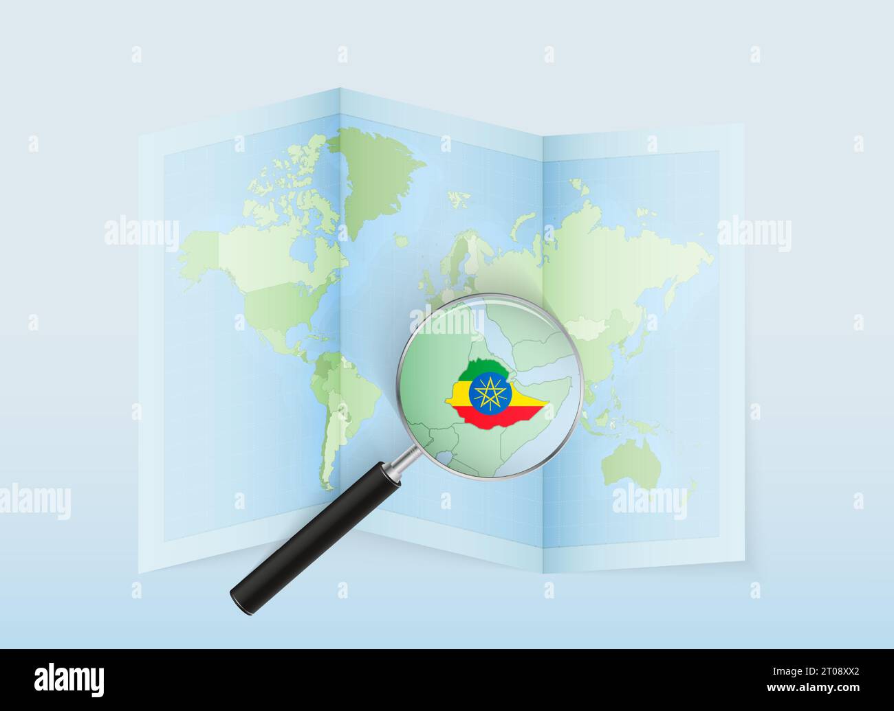 A folded world map with a magnifying lens pointing towards Ethiopia ...