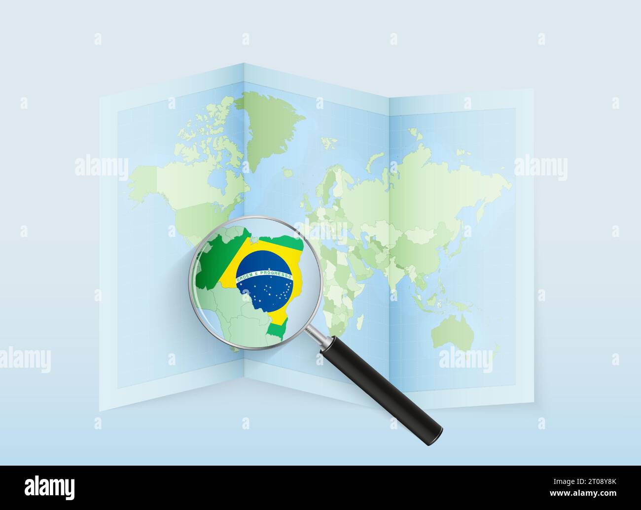 A folded world map with a magnifying lens pointing towards Brazil. Map ...