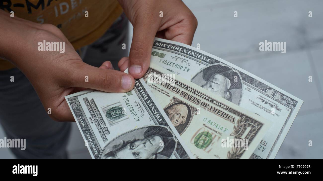 Child's hand holding Banknotes.concept of pocket money Stock Photo - Alamy
