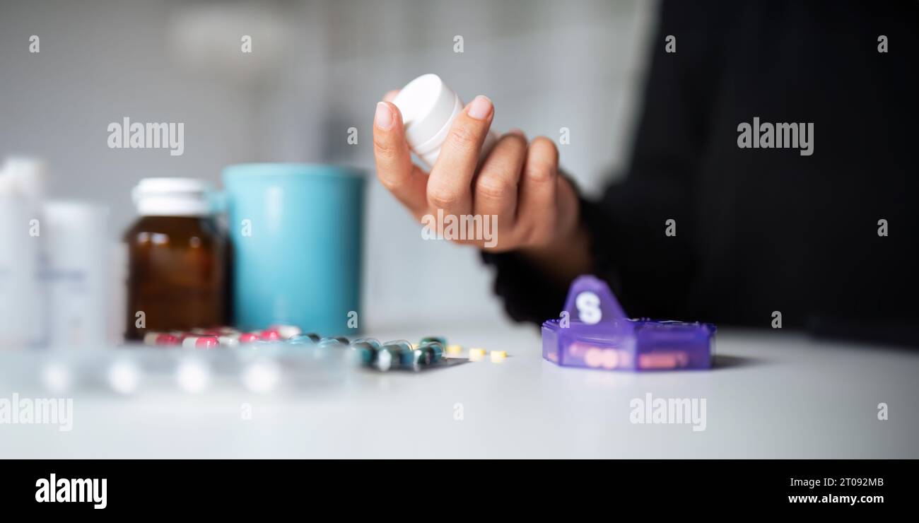 Women organize check the medicine bottle her medication into pill ...