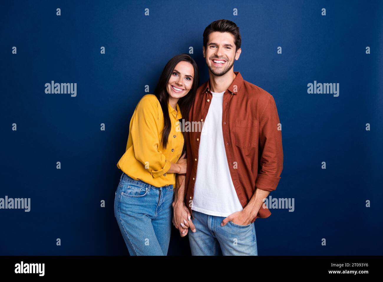 Portrait of idyllic cheerful partners toothy smile cuddle hold arms ...