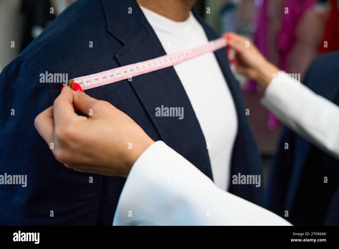 Seamstress taking customer body measurements in atelier Stock Photo - Alamy