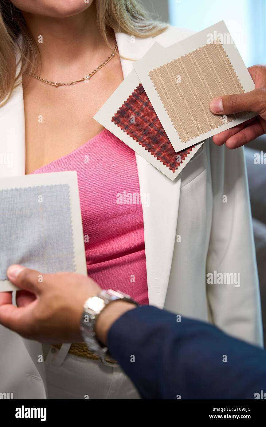 Couturier picking fabric color according to client skin tone Stock ...